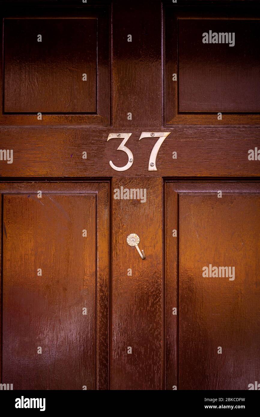 House number 37 on a black wooden front door Stock Photo - Alamy