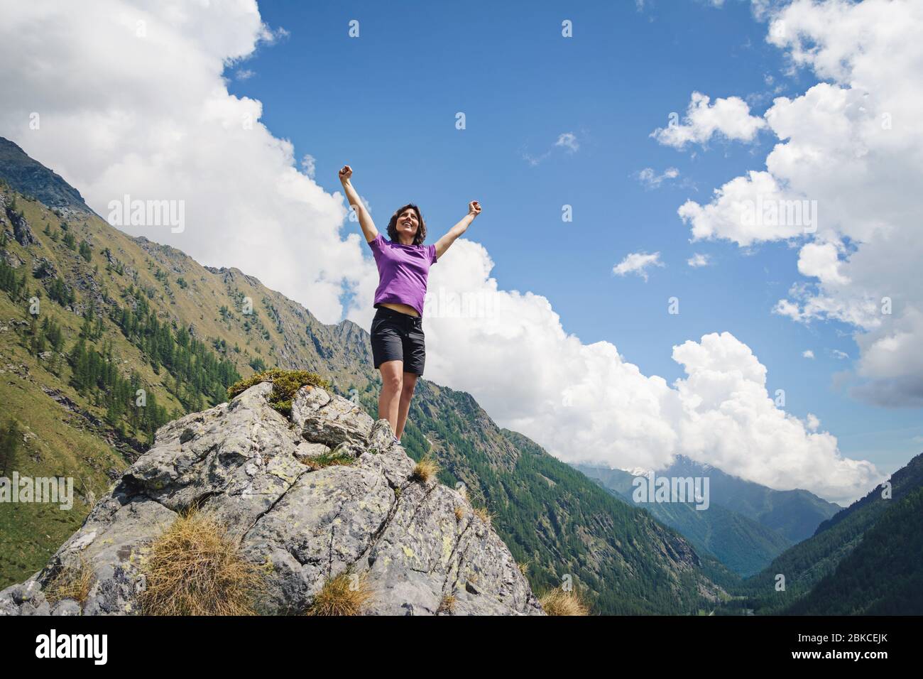 woman standing on the top of mountain in italian Alps. Gran Paradiso ...
