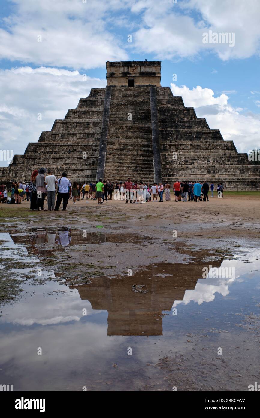 Tourists visiting the pyramids of the Chichen Itza archaeological site ...