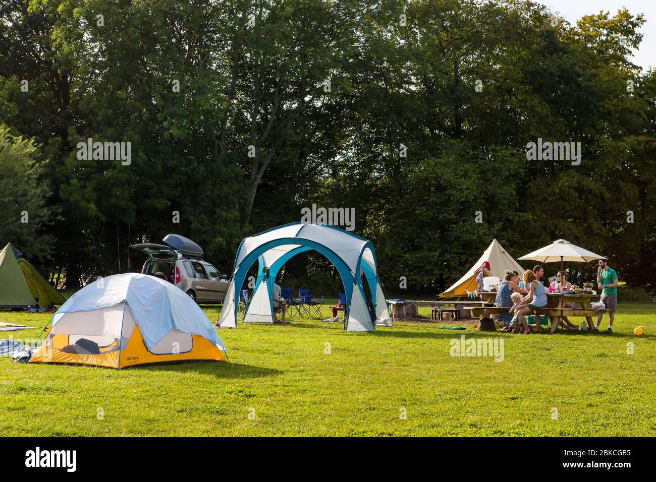 Wide shot of busy camping field at Wowo's, a family campsite in Sussex ...