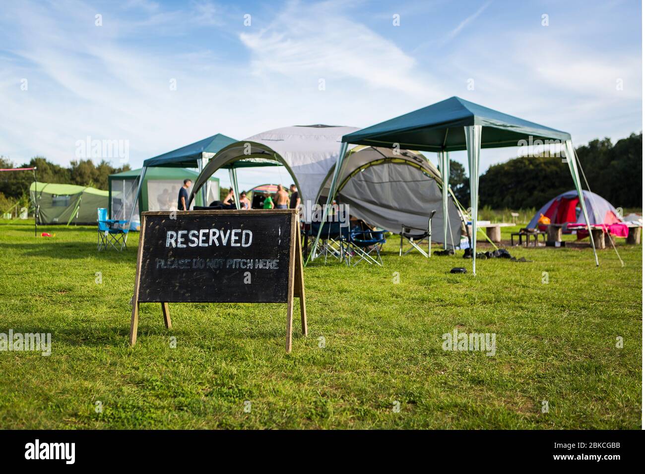 Wide shot of busy camping field at Wowo's, a family campsite in Sussex ...