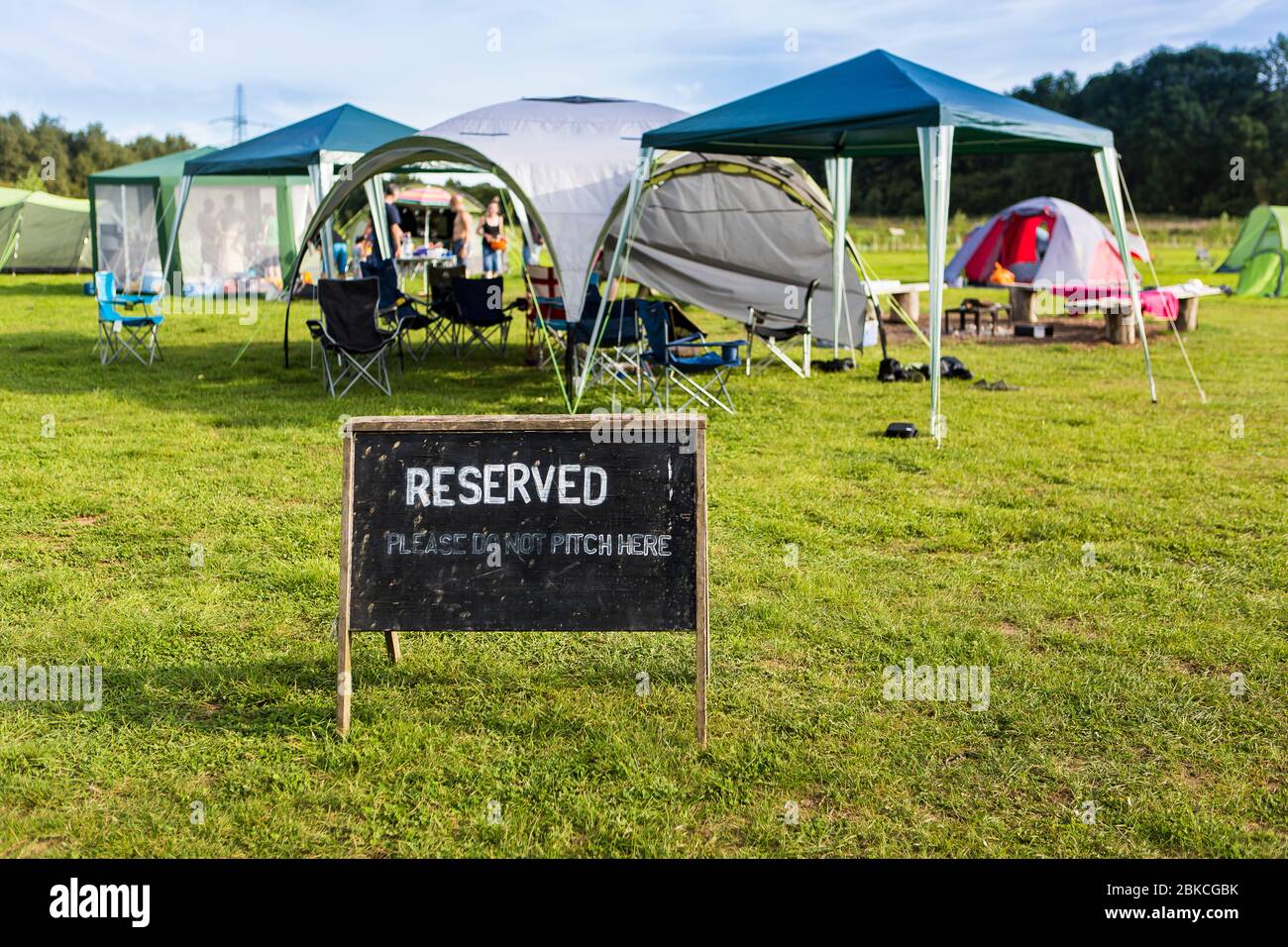 Wide shot of busy camping field at Wowo's, a family campsite in Sussex ...
