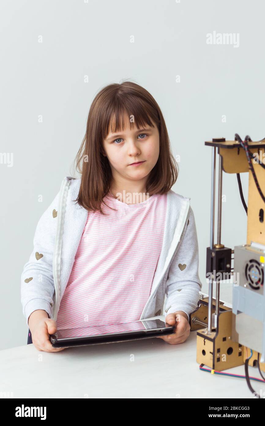 Child student makes the item on the 3D printer. School, technologies ...