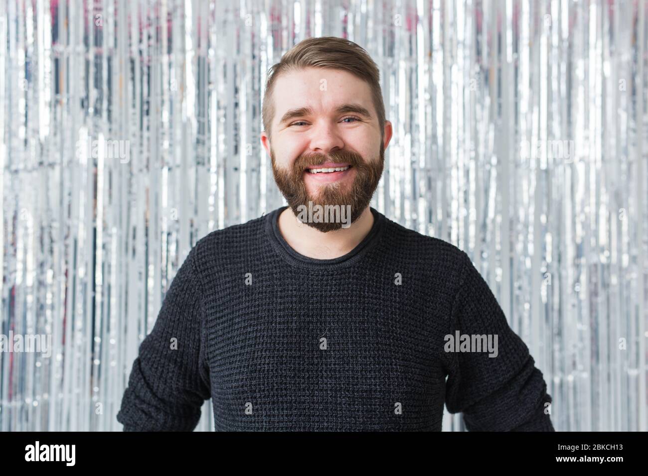 Cheerful guy smiled happily, has excited expression over shiny studio ...