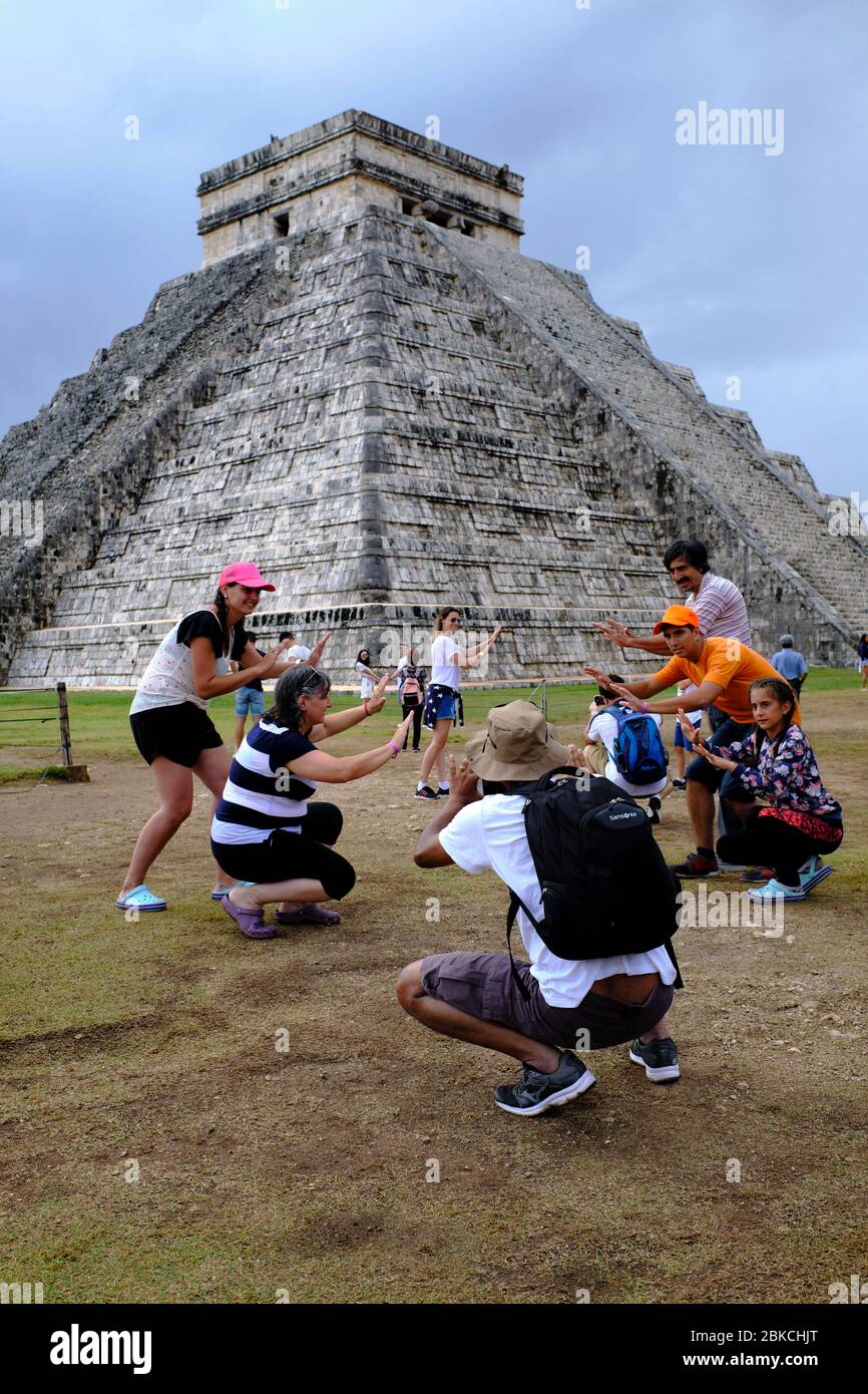 Tourists visiting the pyramids of the Chichen Itza archaeological site ...