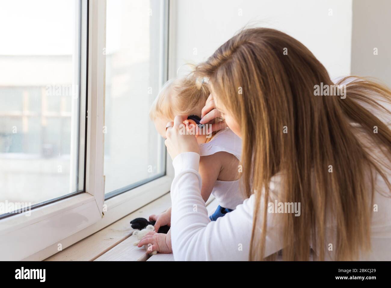 Baby girl wearing a hearing aid. Disabled child, disability and ...