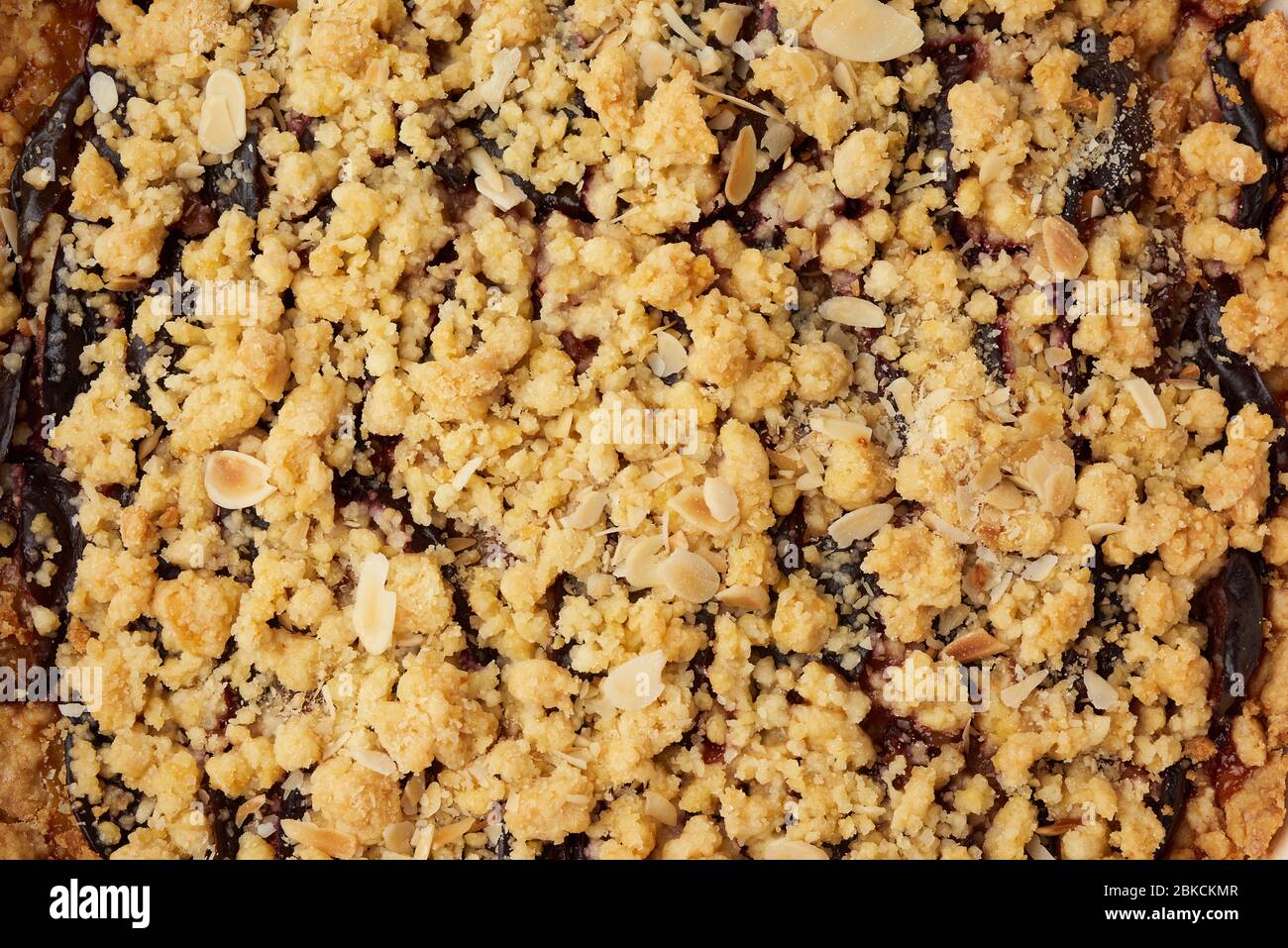 texture of baked crumble pie with blue plum, delicious dessert, top ...
