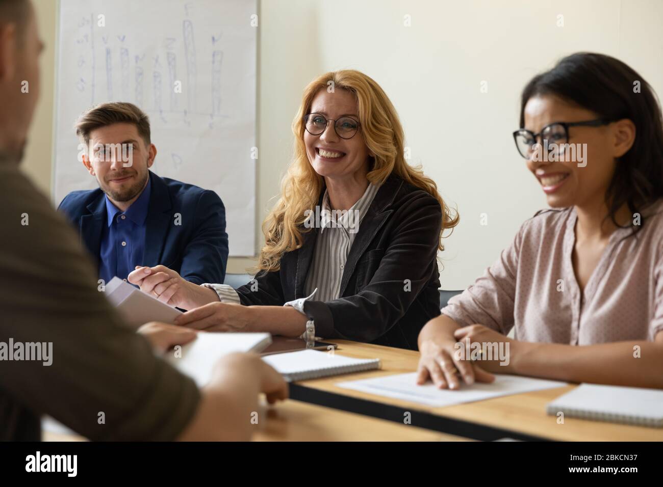 Three happy HR businessman and businesswoman speaking during work ...