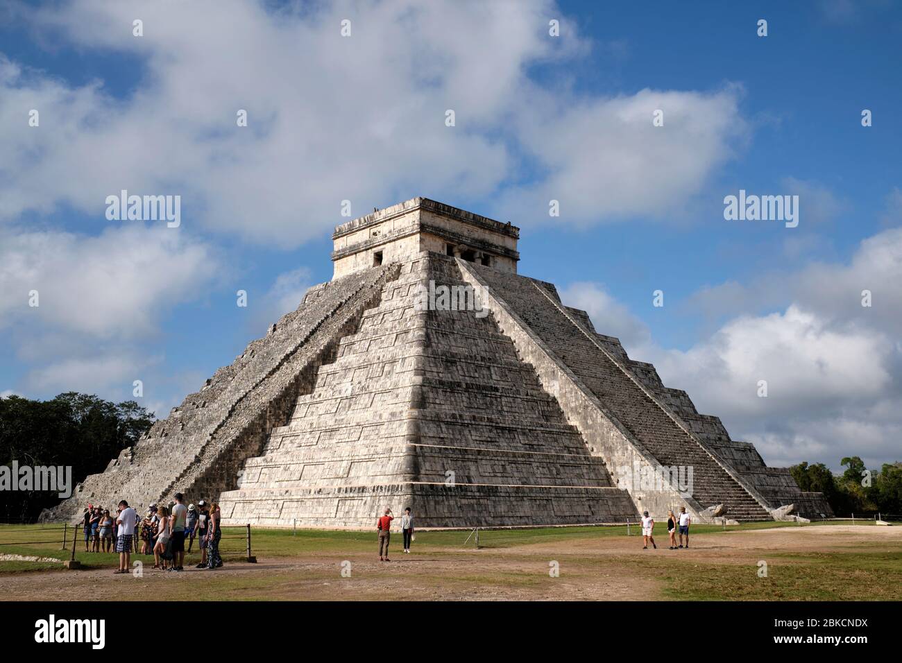Tourists visiting the pyramids of the Chichen Itza archaeological site ...
