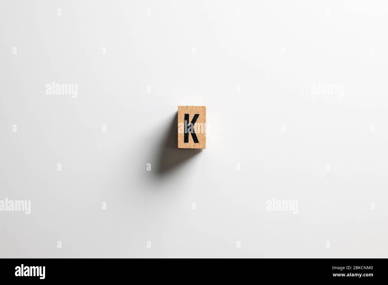 " K " text made of wooden cube on White background with clipping path ...