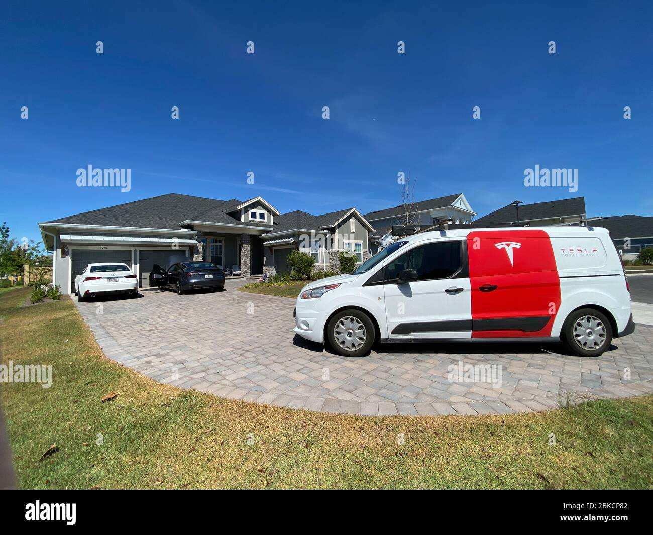 Orlando, FL/USA-4/1/20: A Tesla repair truck in the driveway of a Tesla ...
