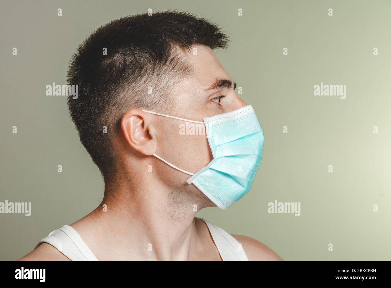 Closeup of face male patient in medical mask on self isolation during ...