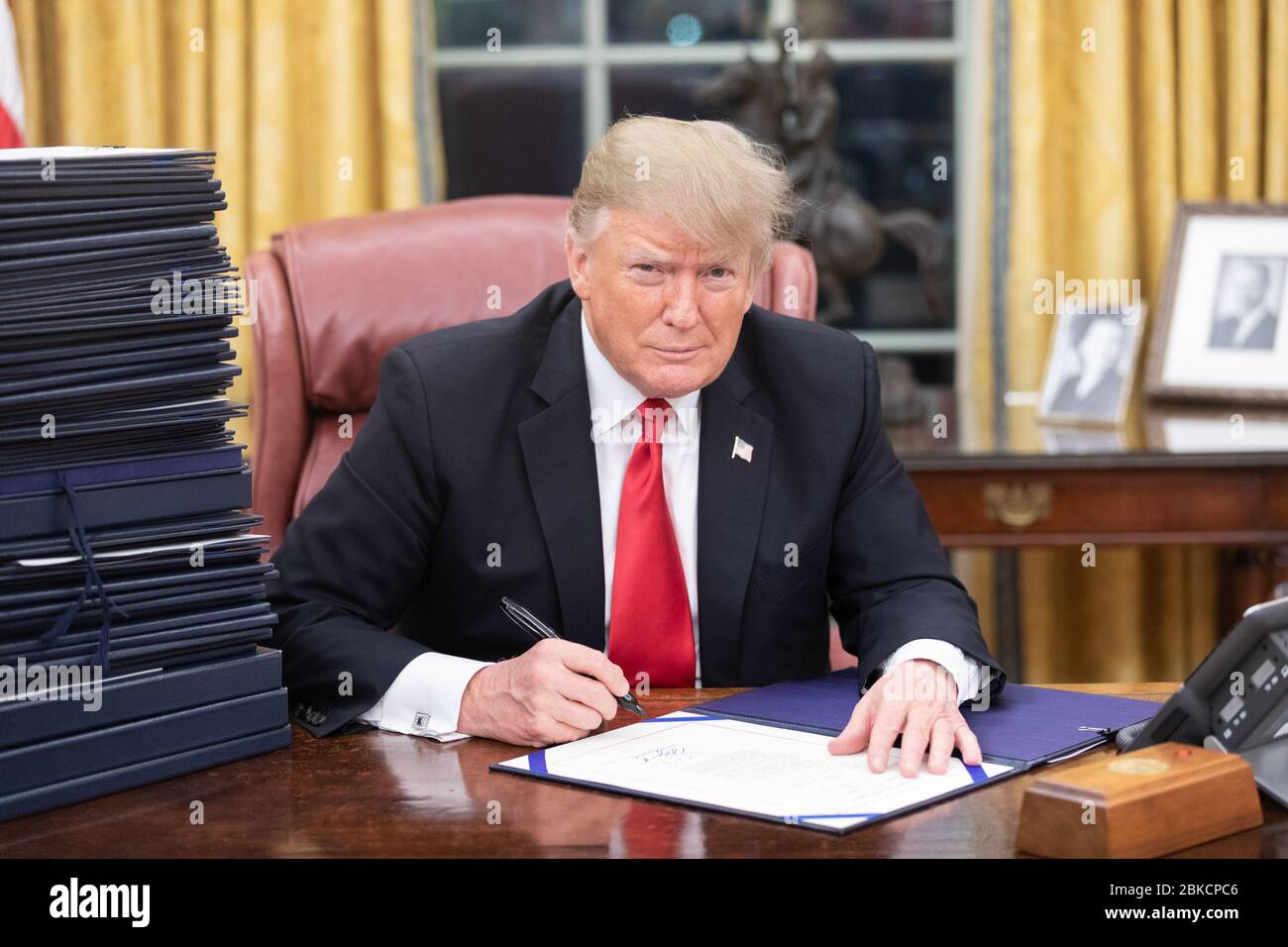 President Donald J. Trump is pictured at his desk in the Oval Office on ...