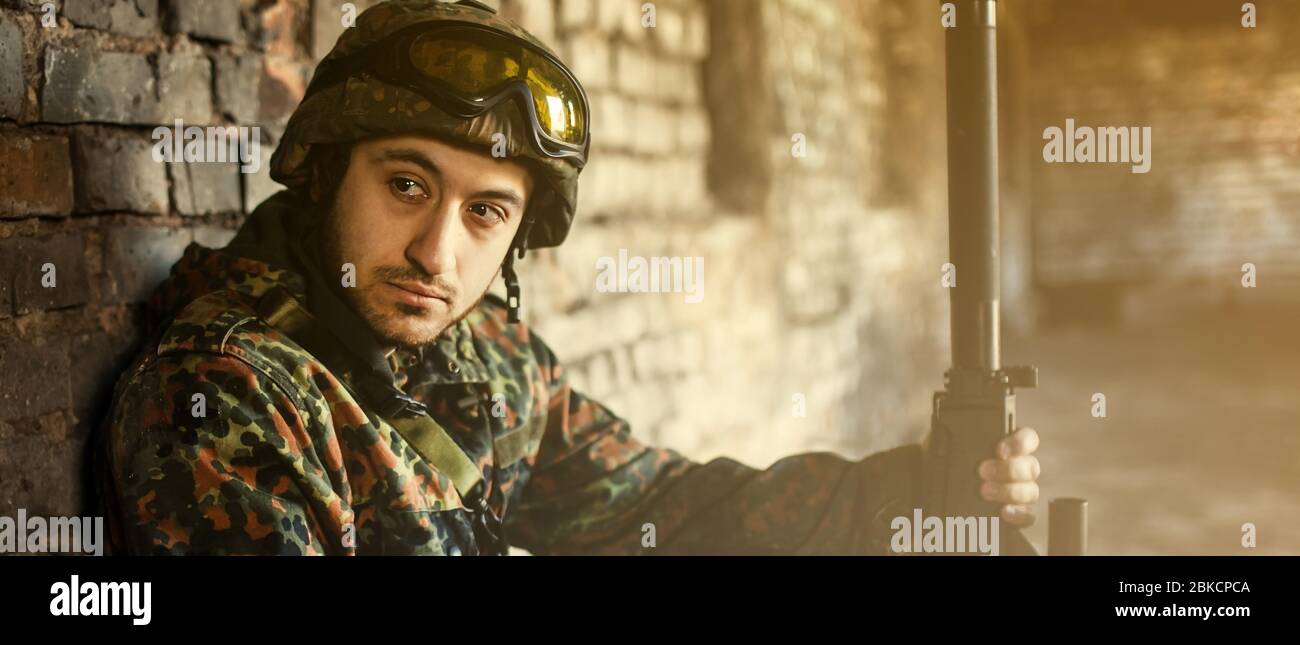 A man is a military soldier in a helmet and camouflage clothing ...