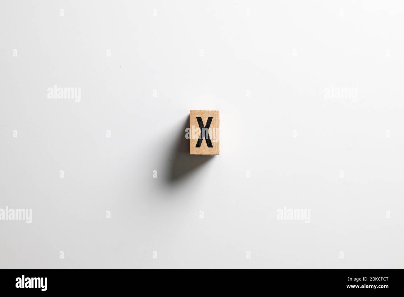 " X " text made of wooden cube on White background with clipping path ...