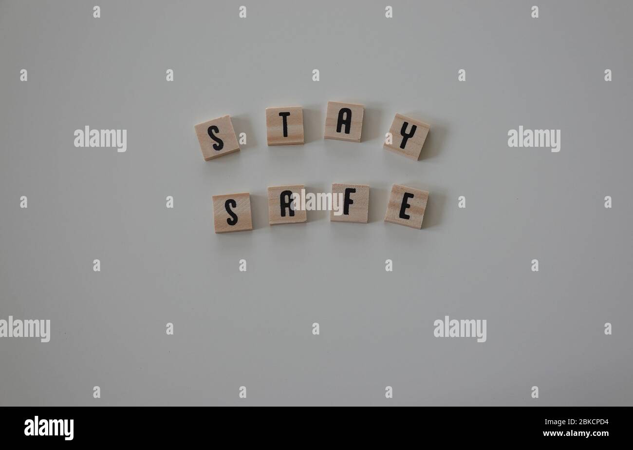 Stay Safe written in wooden letter tiles on a white background. Concept ...
