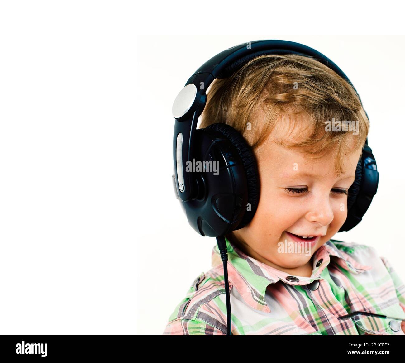 little cute boy in big earphones happy smiling isolated on white ...