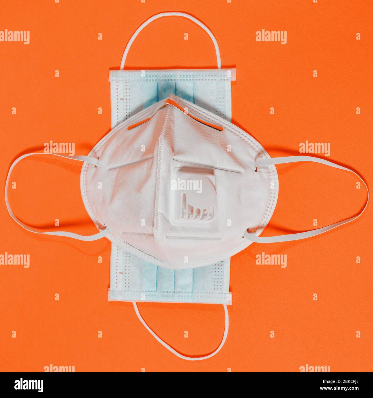 Medical mask with valve and surgical mask on orange background 2021 ...