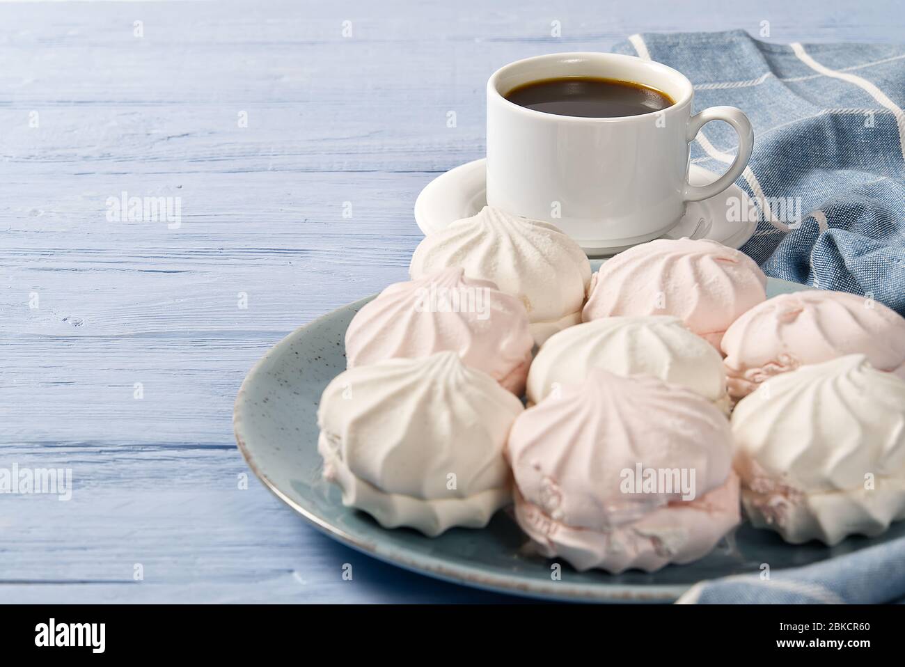 Good morning banner. Cup of coffee and homemade dessert zephyr, Zefir on light blue wood ...