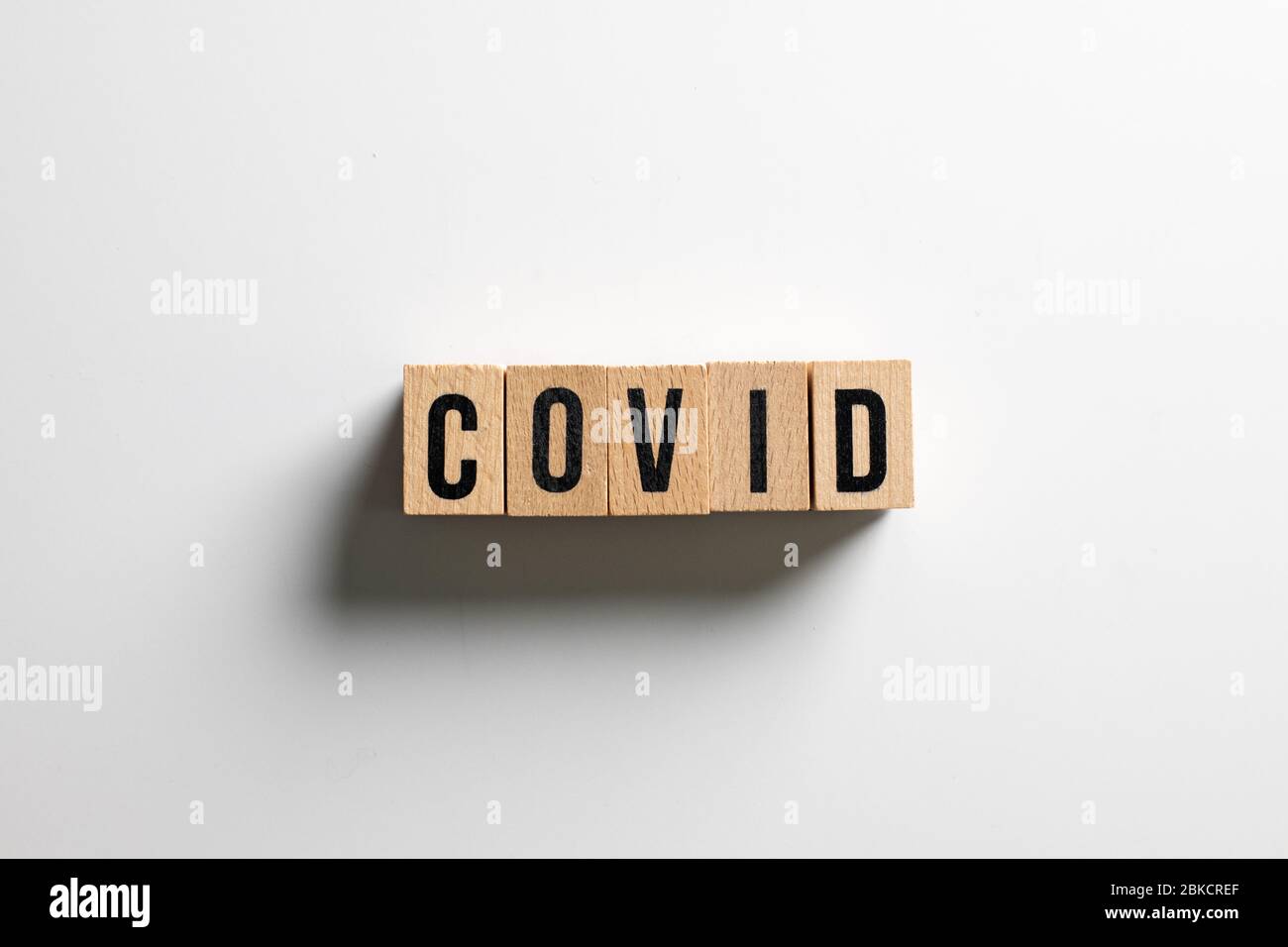 " covid " text made of wooden cube on White background Stock Photo - Alamy