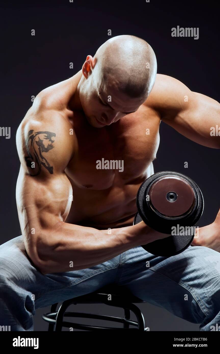 Close-up of a power fitness man's biceps. Muscular bodybuilder guy ...