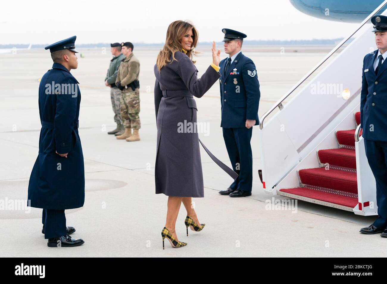 First Lady Melania Trump waves as she boards the aircraft Bright Star ...