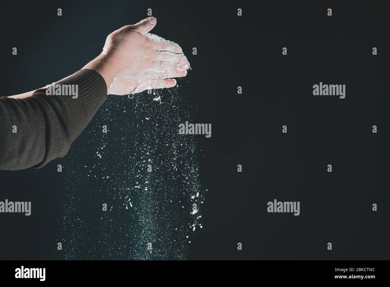 hand of woman cook in kitchen pouring white dust flour flour table for ...