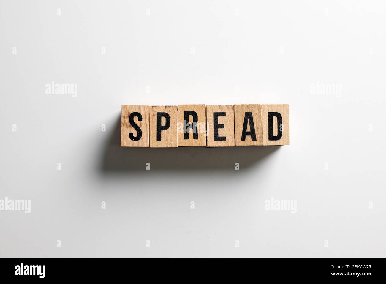 " spread " text made of wooden cube on White background Stock Photo - Alamy