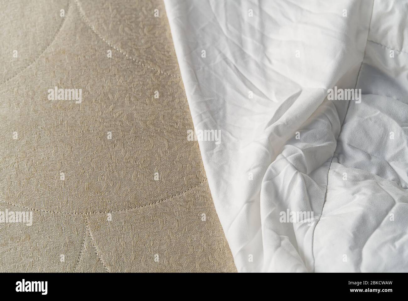 Top view of wrinkles on an unmade bed sheet after waking up in the ...