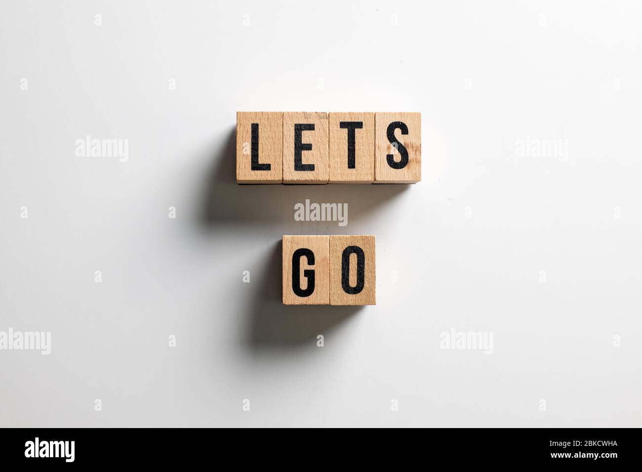 " lets go " text made of wooden cube on White background Stock Photo ...