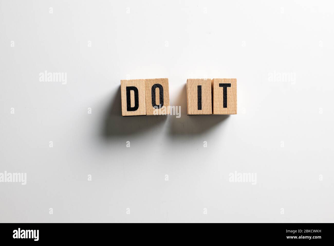 " do it " text made of wooden cube on White background Stock Photo - Alamy