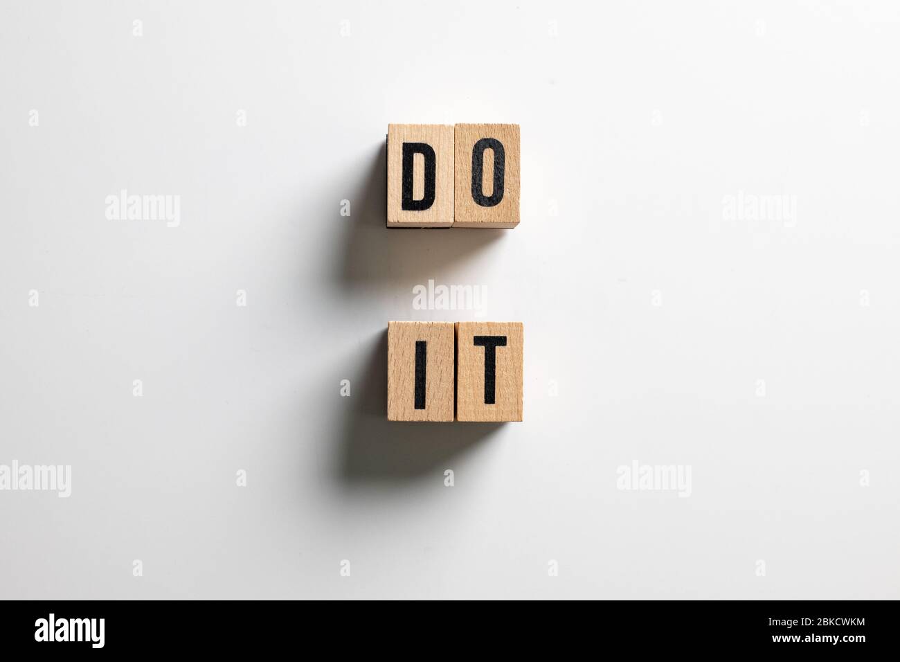 " do it " text made of wooden cube on White background Stock Photo - Alamy