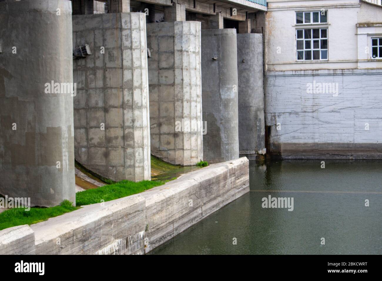 a dam at a hydroelectric power station, a building that produces ...