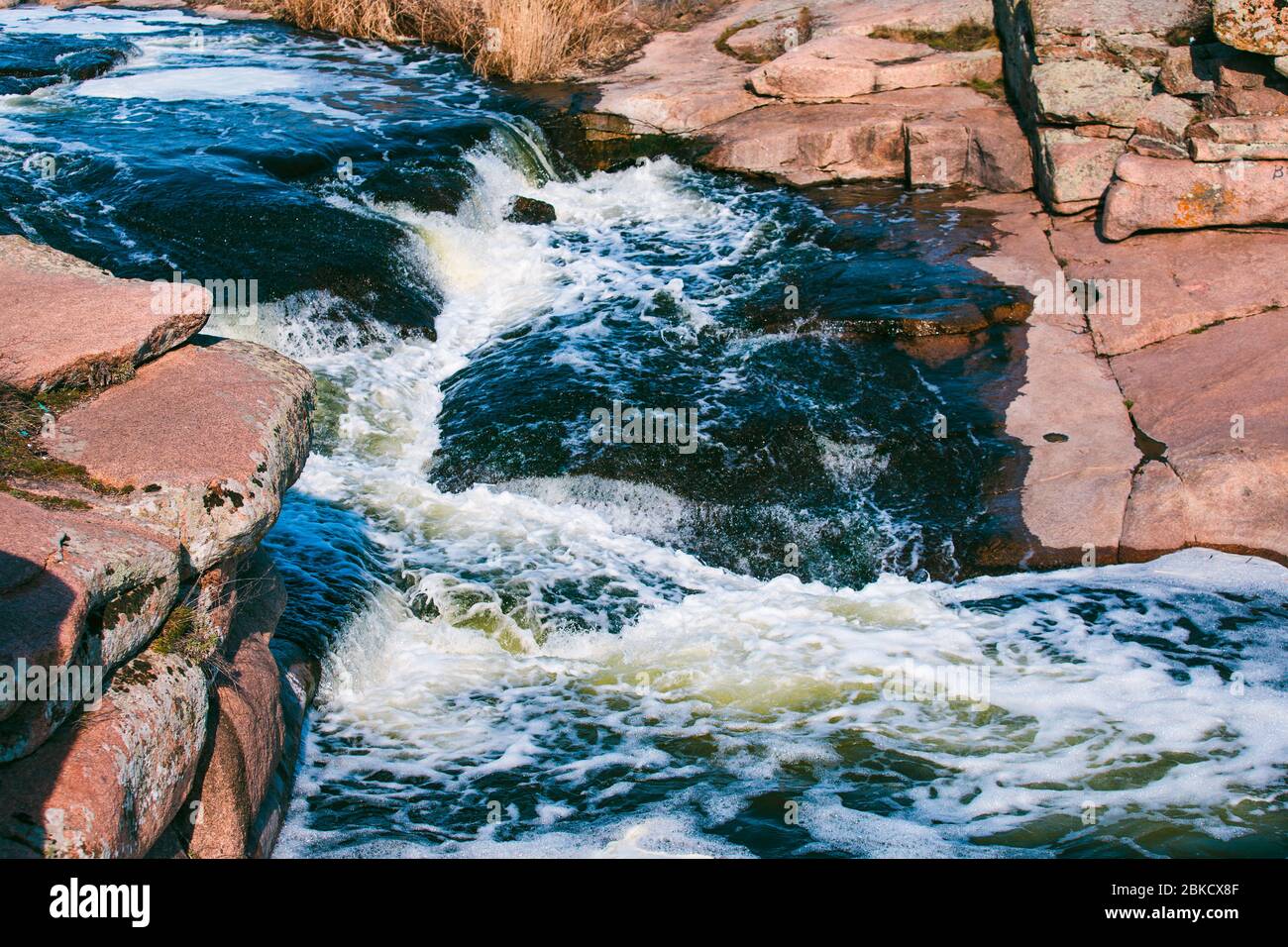 Waterfall spring water landscape at the daytime. Magmatic stones breed ...