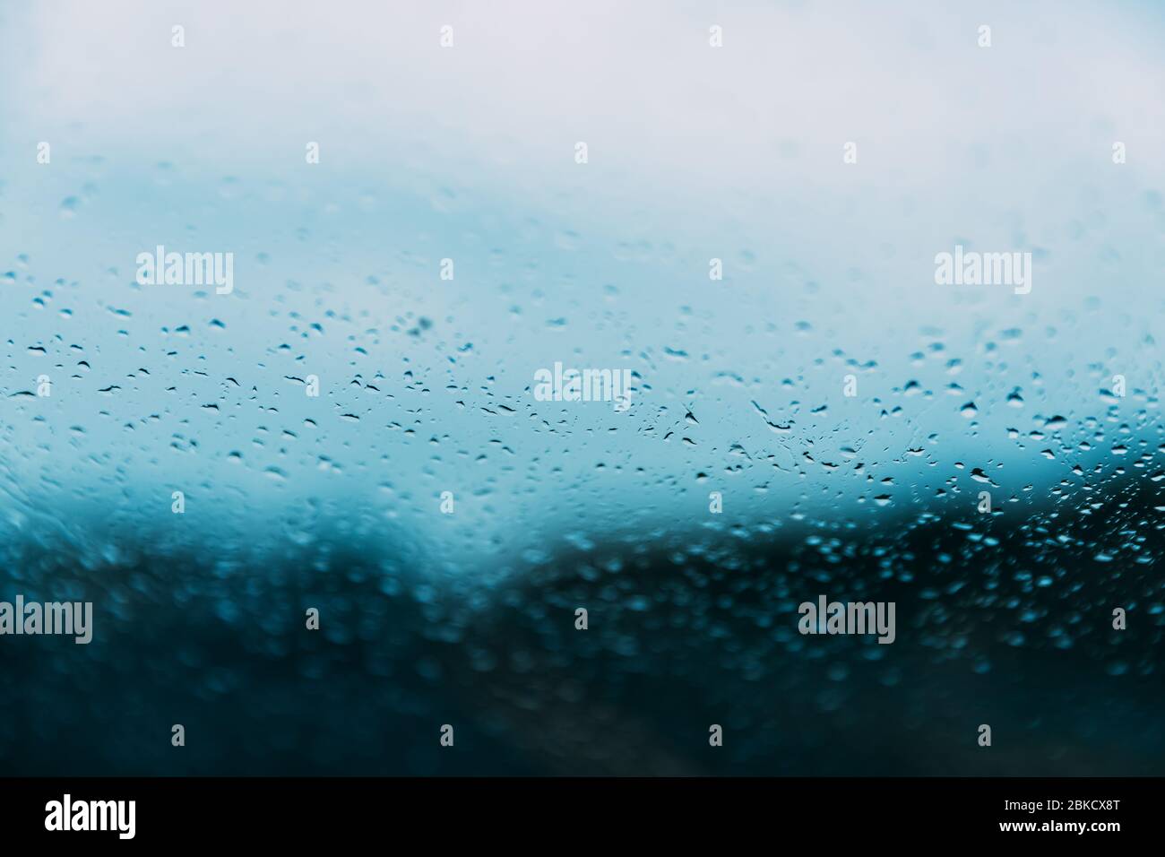 Raindrops on a car windshield. Rainy window. Drops on the glass. Dark ...