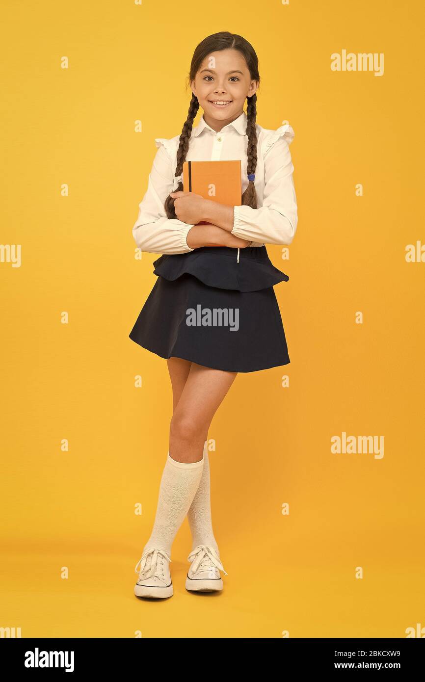 School girl formal uniform hold book. School lesson. Study literature ...