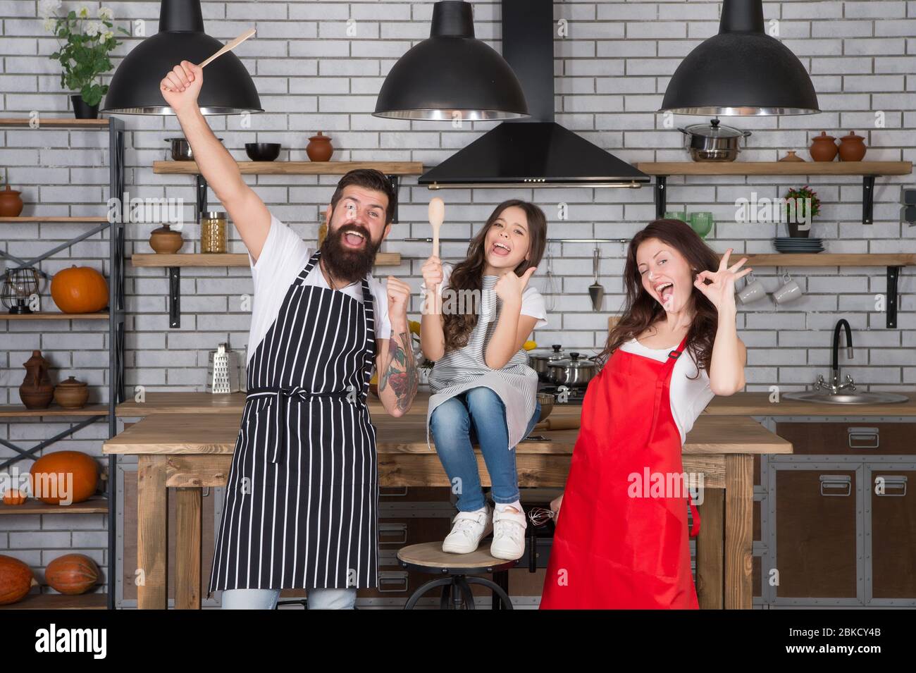 Just for fun. Family holidays. Mother father and daughter cooking ...