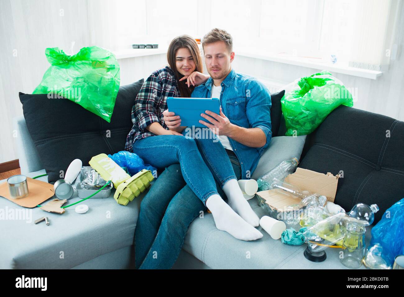 Environmental pollution concept. Silin young couple on the sofa in the ...