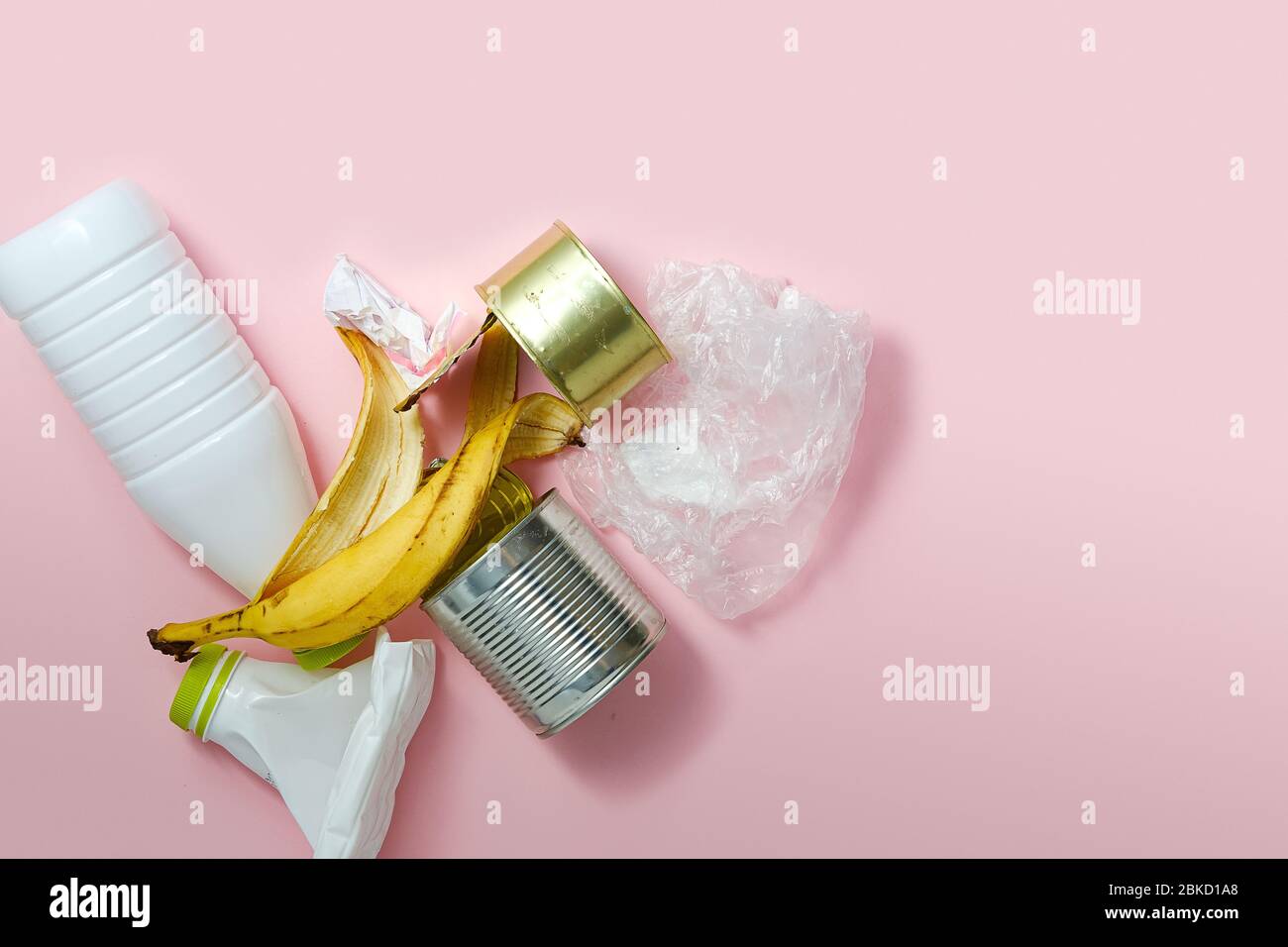 mixed trash on a pink background. Separate waste collection on a pink ...