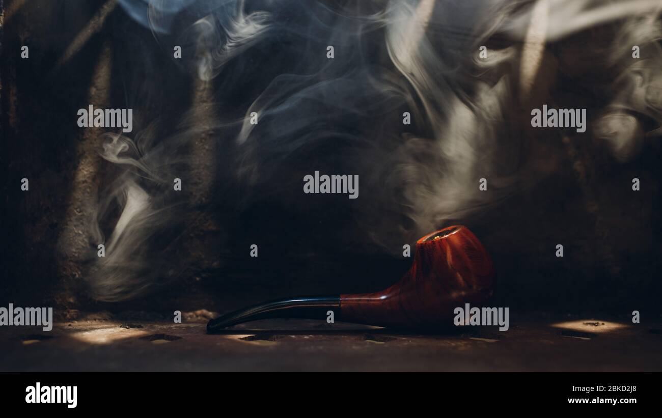 Smoking pipe on steel background with smoke Stock Photo - Alamy
