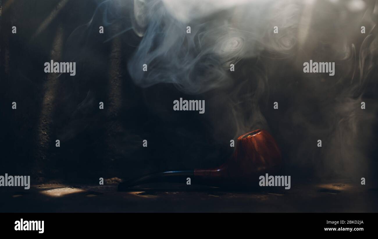 Smoking pipe on steel background with smoke Stock Photo - Alamy