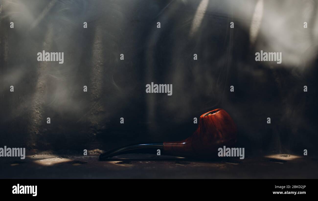Smoking pipe on steel background with smoke Stock Photo - Alamy