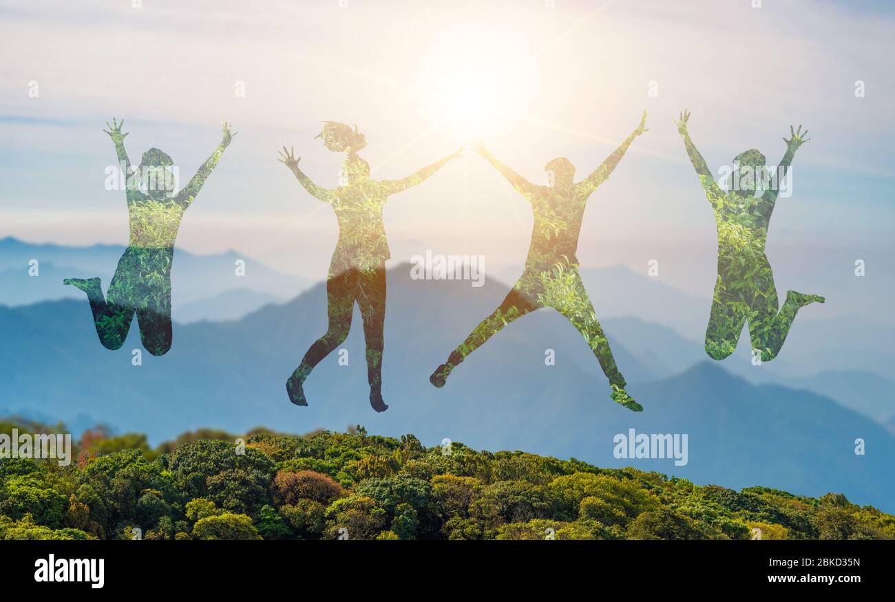 Young people are jumping with joy in the midst of the wild nature ...