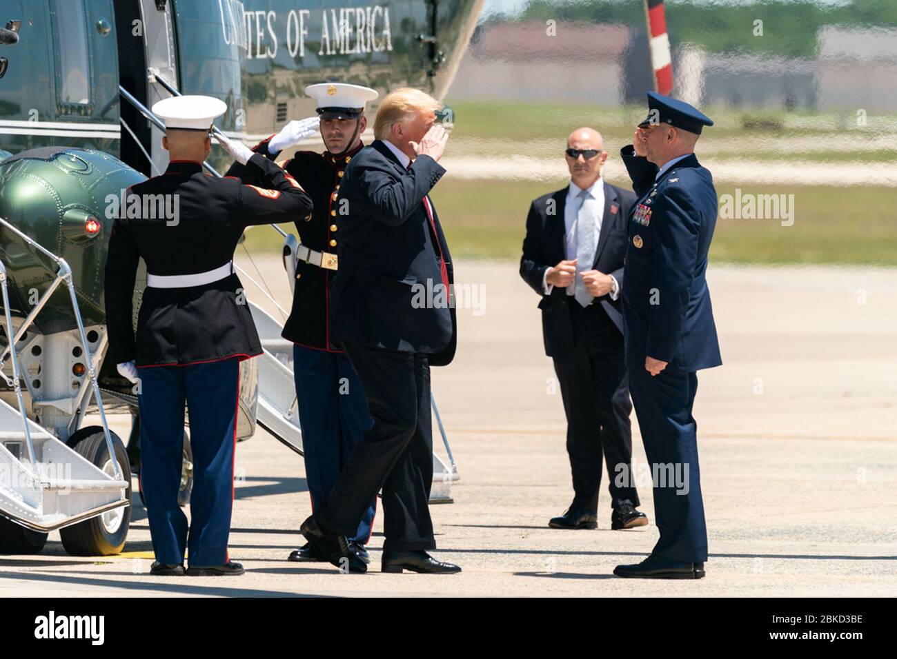 President Donald J. Trump returns a salute as he disembarks Marine One ...