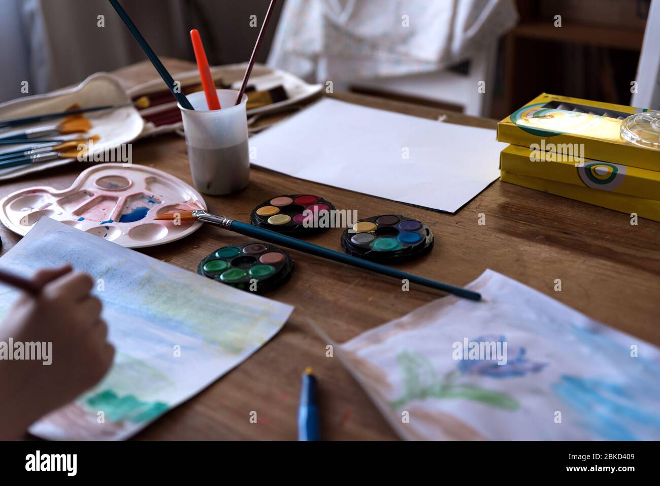 Child painting with paints. Home school. Art work at home. A place to ...