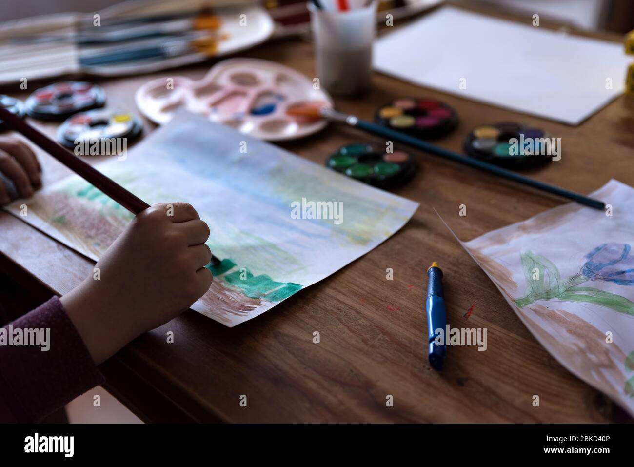 Child painting with paints. Home school. Art work at home. A place to ...