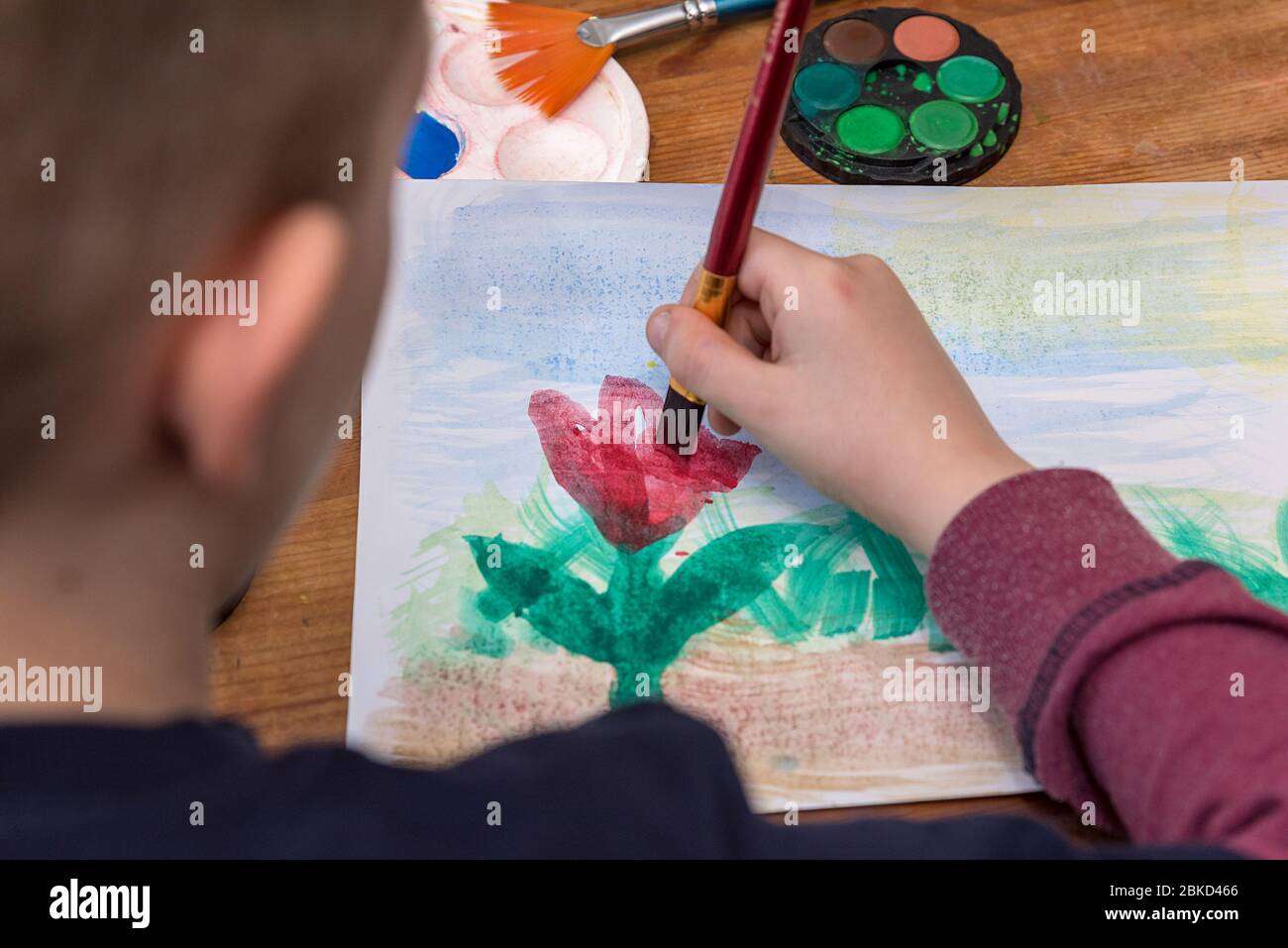 Child painting with paints. Home school. Art work at home. A place to ...