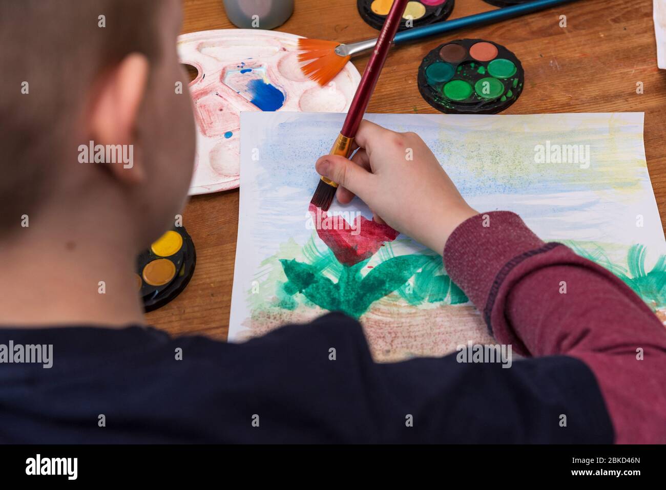 Child painting with paints. Home school. Art work at home. A place to ...