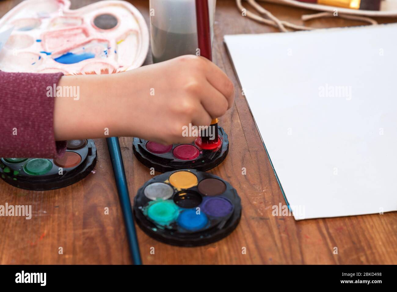Child painting with paints. Home school. Art work at home. A place to ...