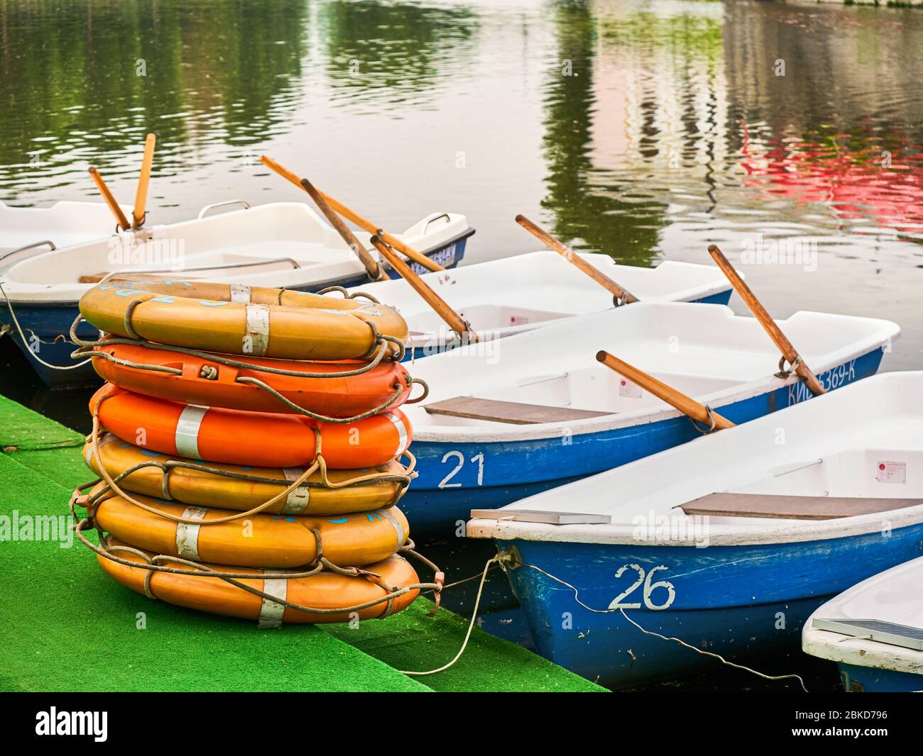Bright orange lifelines and boats at the dock Stock Photo - Alamy